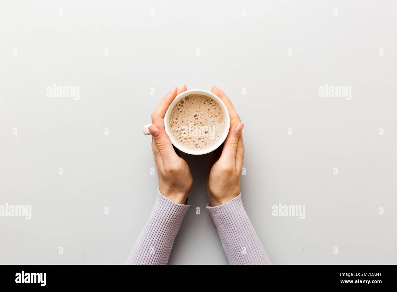 Minimalistic style woman hand holding a cup of coffee on Colored ...