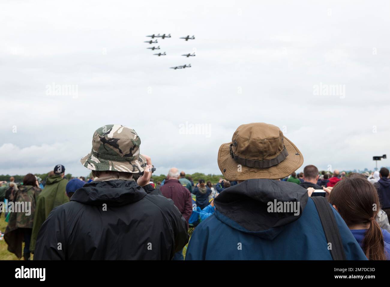 Plane spotters watch a jet aircraft display team fly past at a show ...