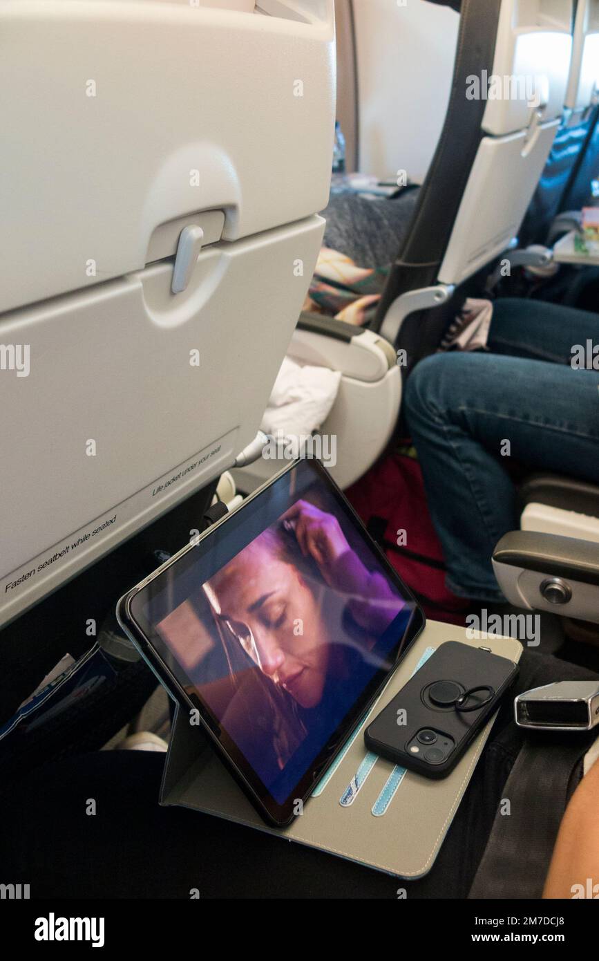 Passenger watching a show film, movie, or television programme on their ...