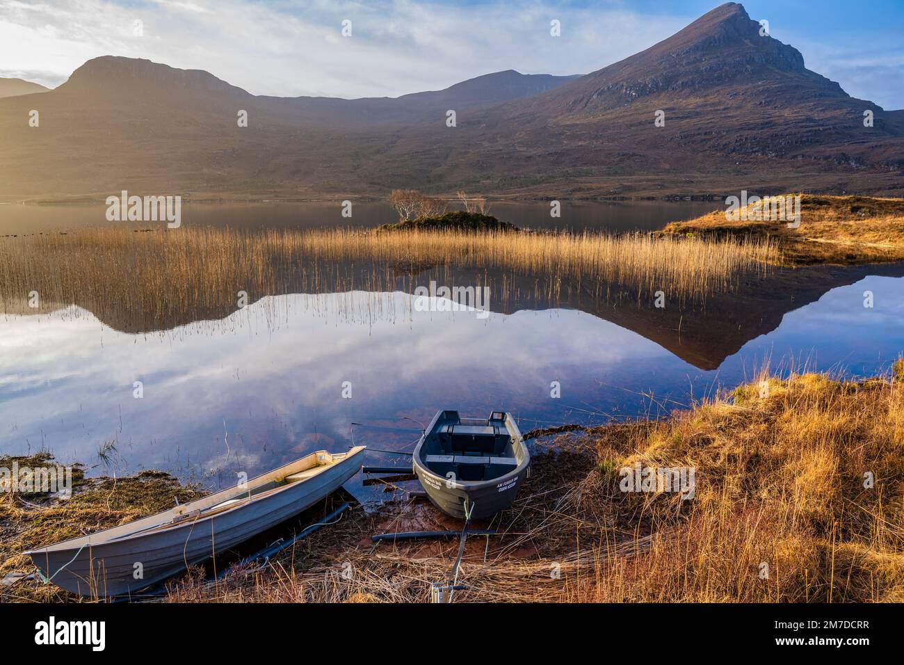 Beached fishermen’s boats on Loch Lurgainn with Sgorr Tuath in the ...