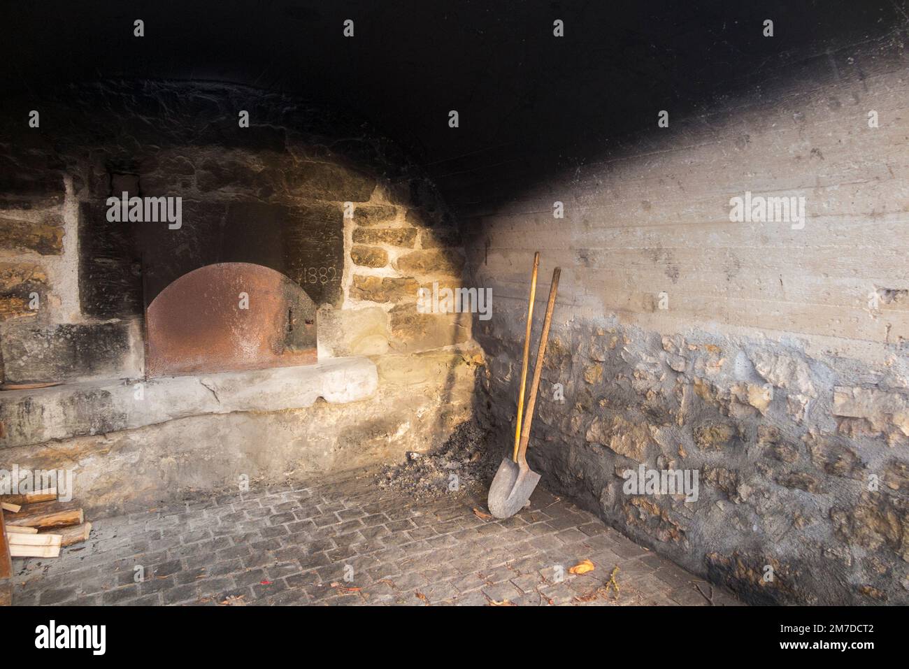 Details, including shuffle spade leaning against the wall and the date ...