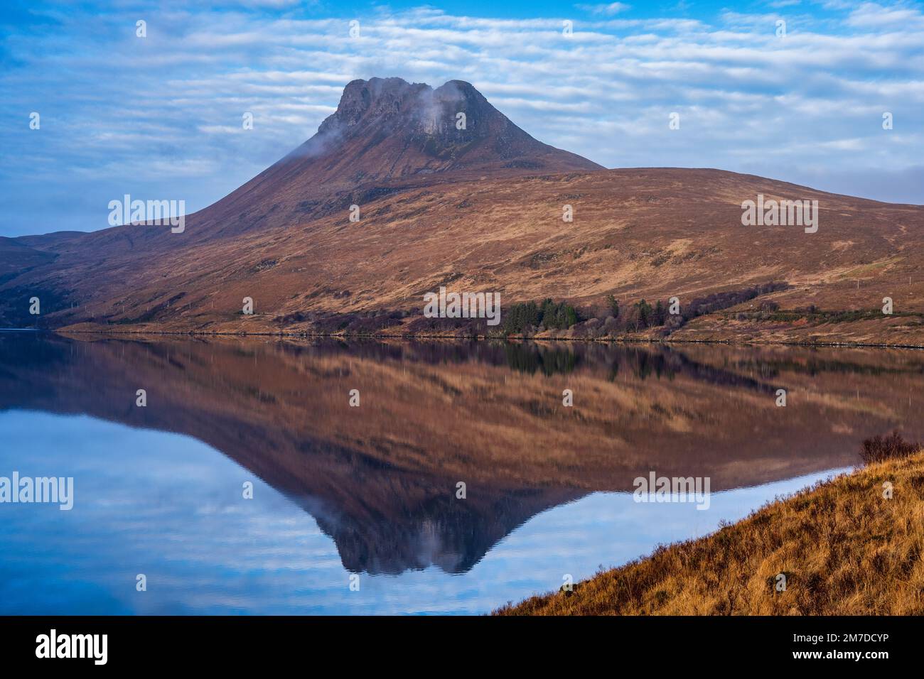 View of Stac Pollaidh reflected in the still water of Loch Lurgainn on ...