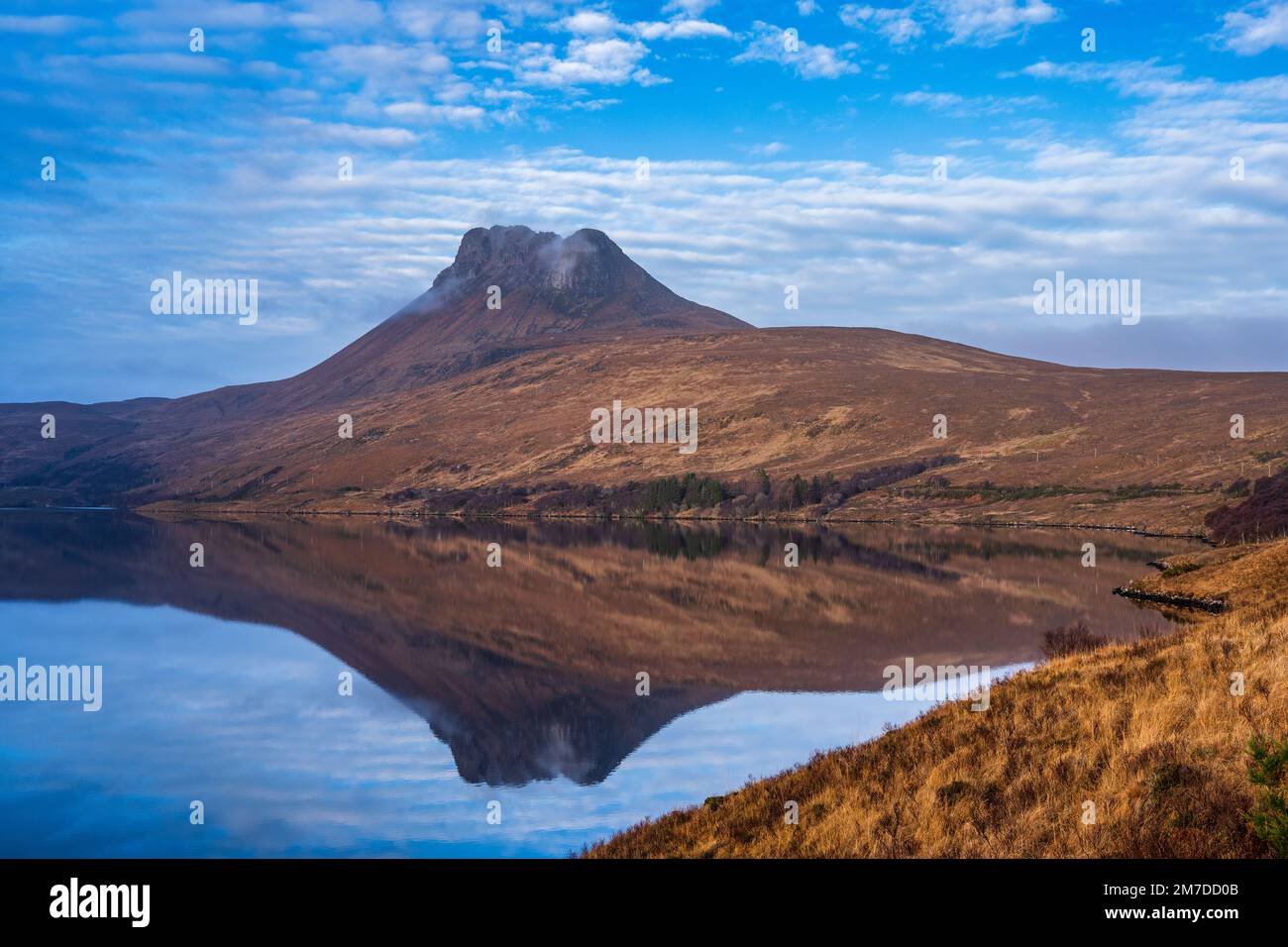 View of Stac Pollaidh reflected in the still water of Loch Lurgainn on ...
