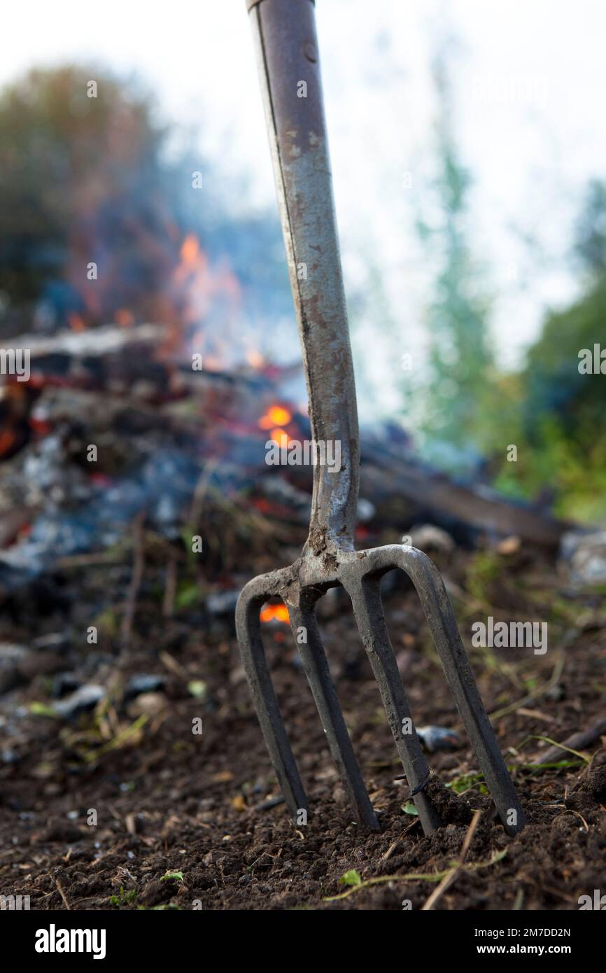 A bonfire on an allotment or garden burning off the garden waste and ...