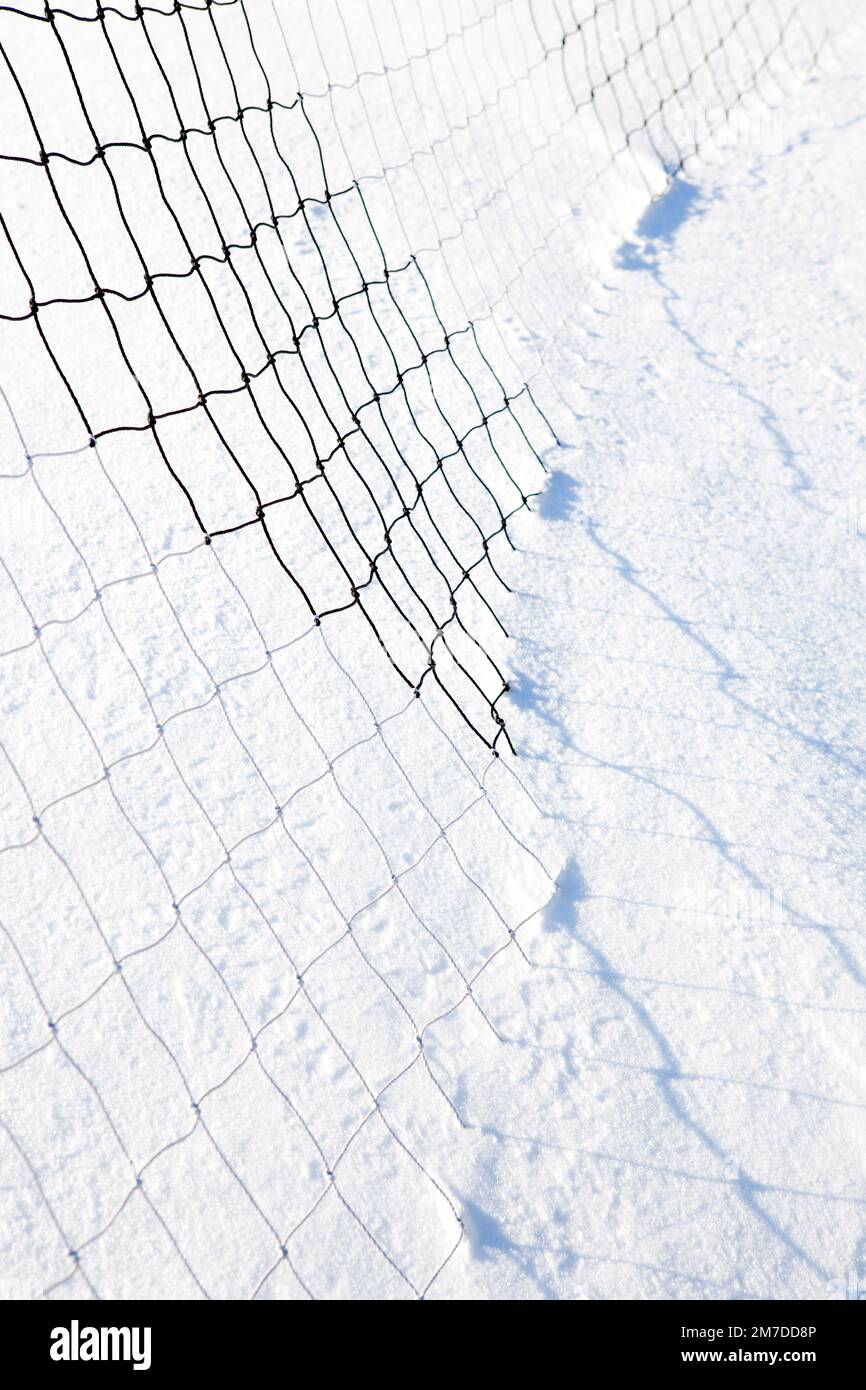 Car tyre tracks left in a deep layer of snow creating an abstract ...