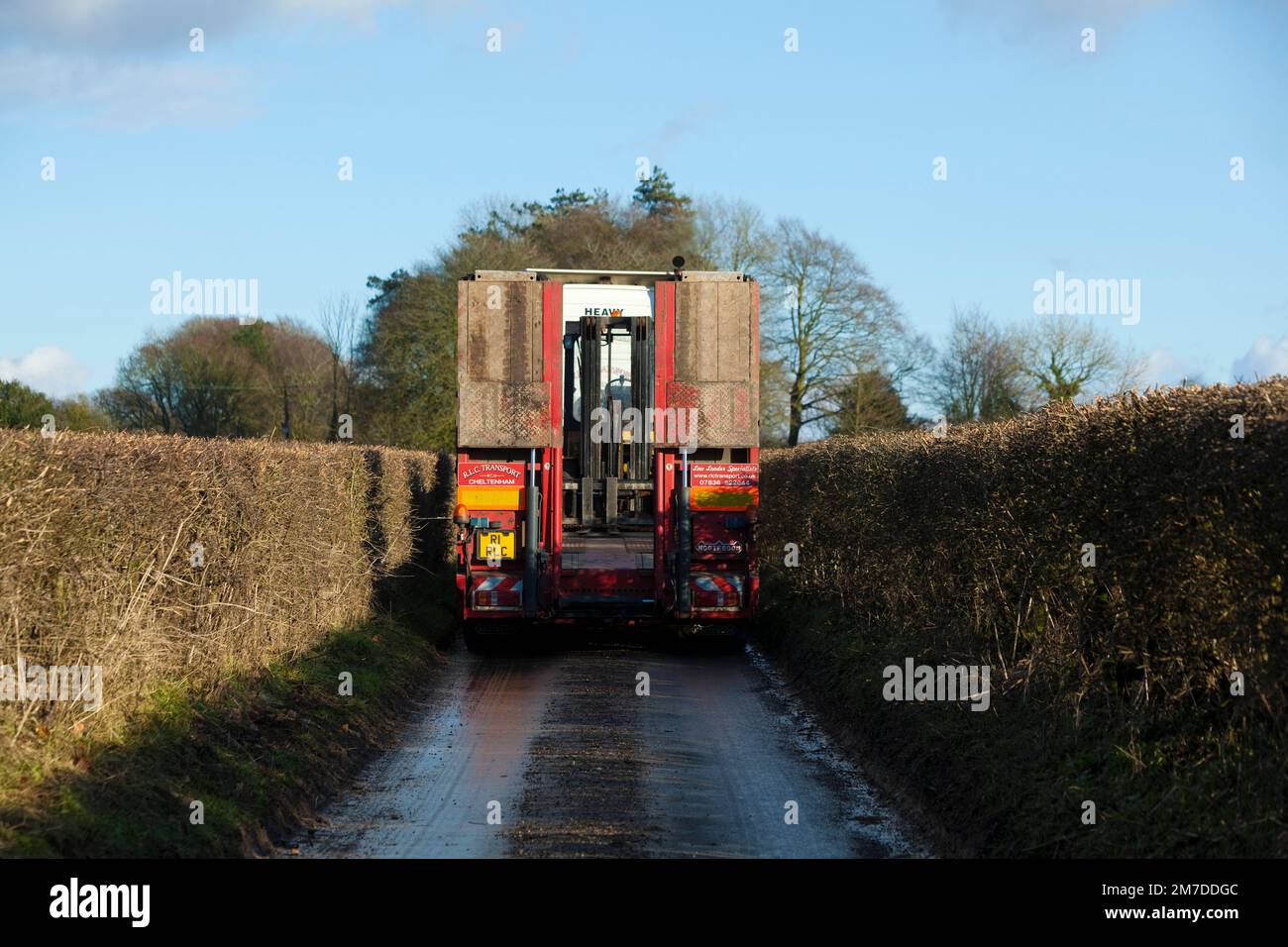 A large lorry blocks a narrow country lane in the cotswolds ...