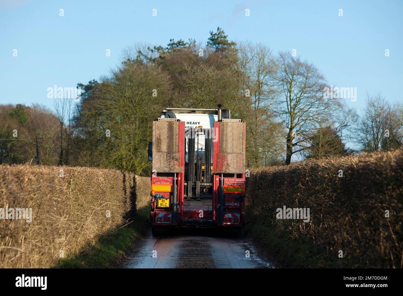 A large lorry blocks a narrow country lane in the cotswolds ...
