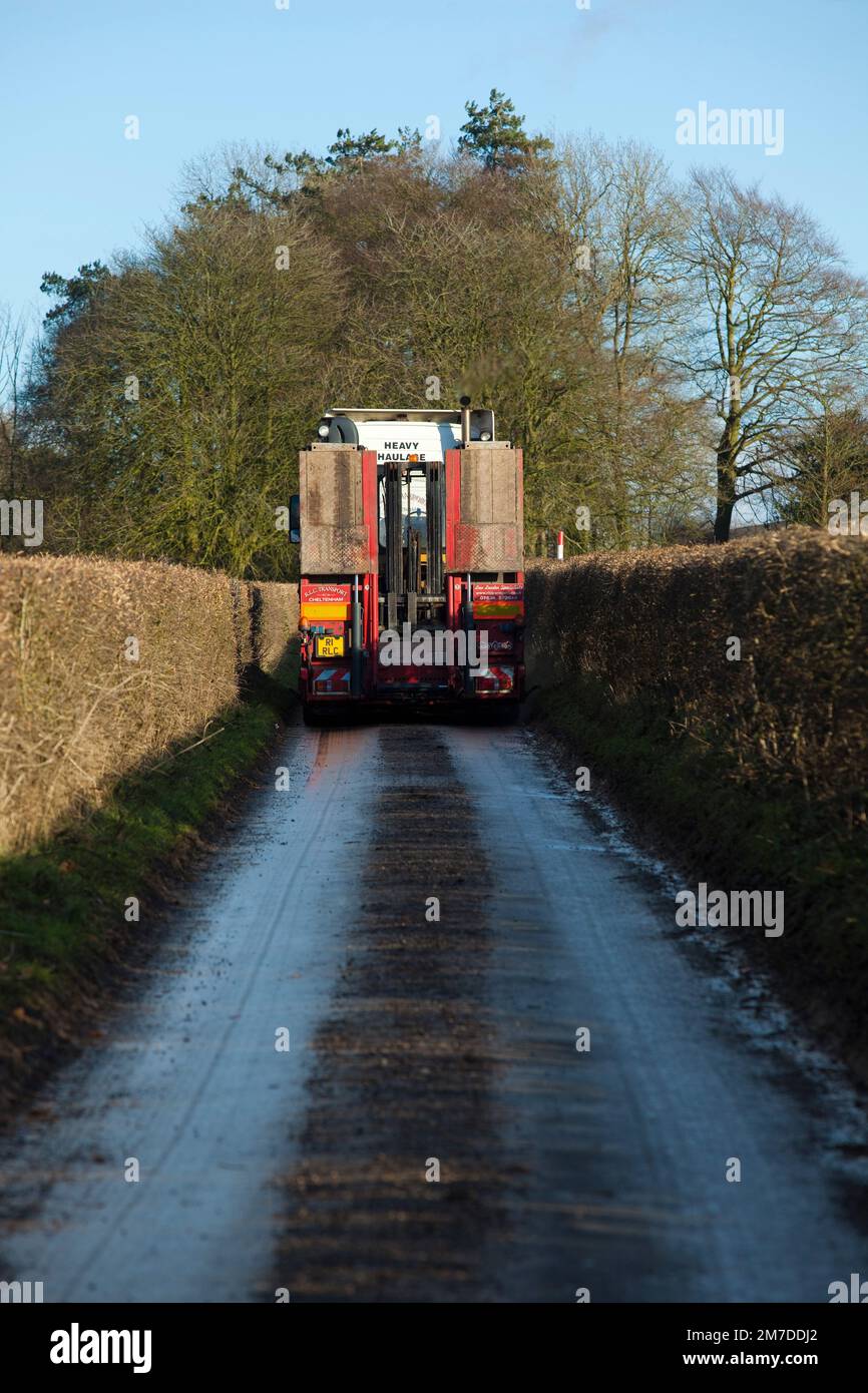 A large lorry blocks a narrow country lane in the cotswolds ...