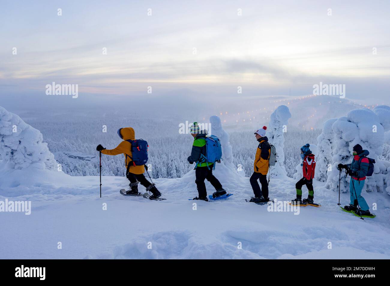 Family with three kids enjoying the view snowshoeing in the frozen ...