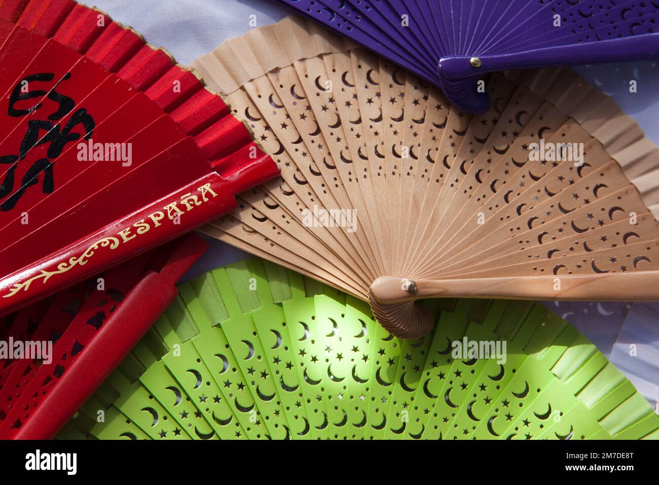Multicoloured traditional spanish fans spread out for sale as ...