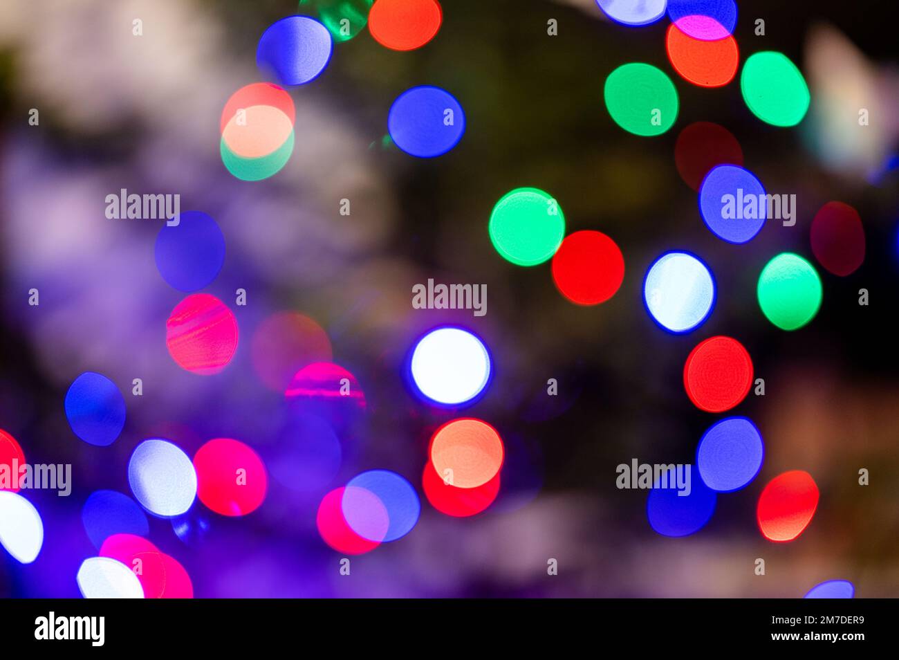 Background full of an unfocused colorful lights. Blurred lights traces ...