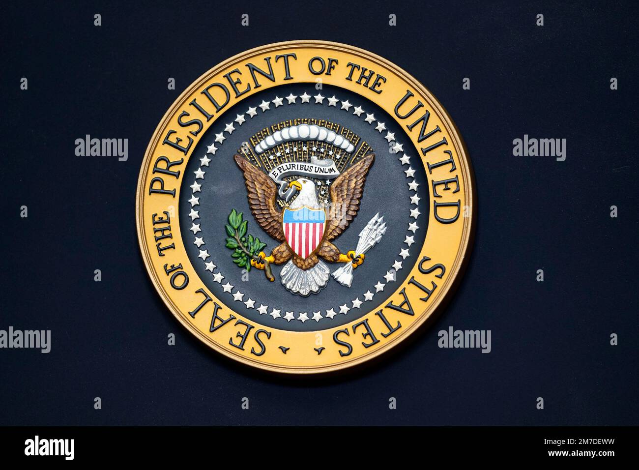 The seal of the President of the United States is displayed on a podium ...