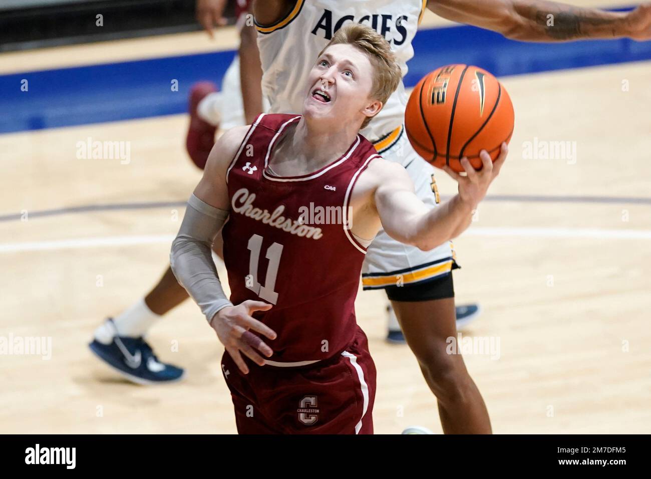 College of Charleston guard Ryan Larson (11) drives past North Carolina ...