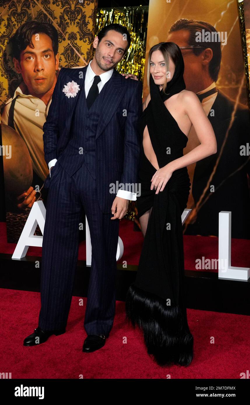 Diego Calva, left, and Margot Robbie, cast members in "Babylon," pose ...