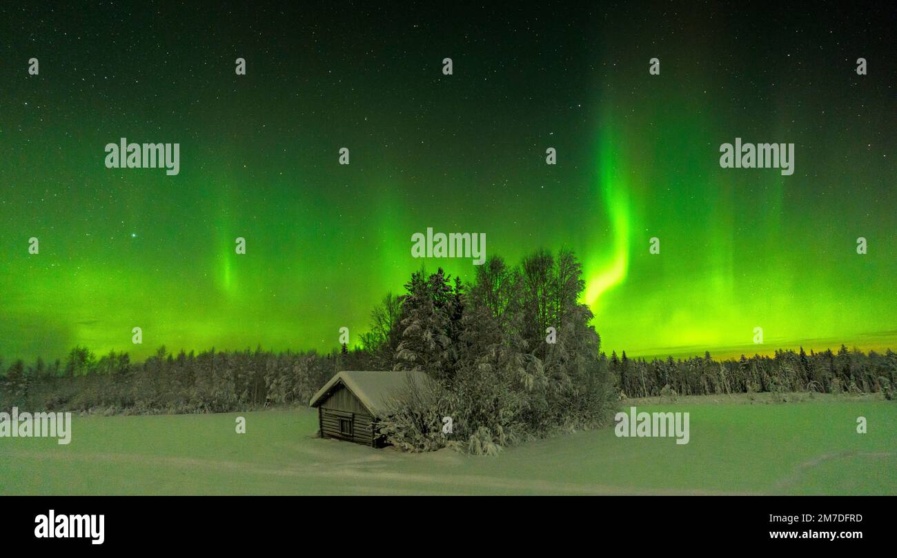 Frozen snowy hut in the winter scenery of Swedish Lapland lit by ...