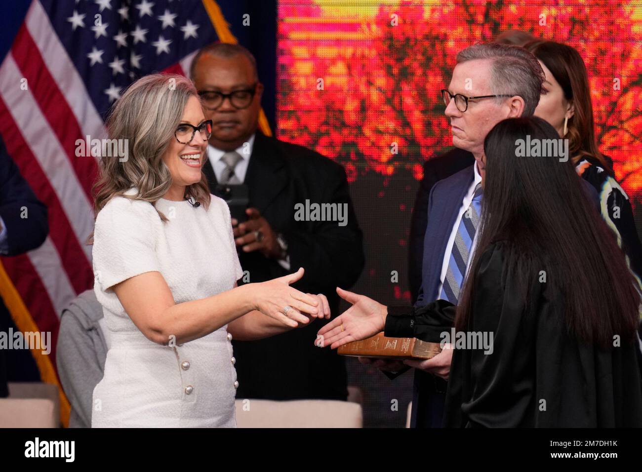 Arizona Democratic Gov. Katie Hobbs, left, smiles after taking the ...