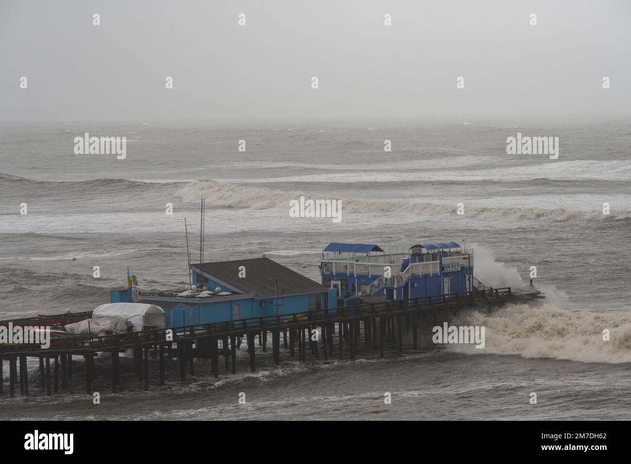Heavy waves crash over Capitola Wharf in Capitola, Calif., Thursday ...