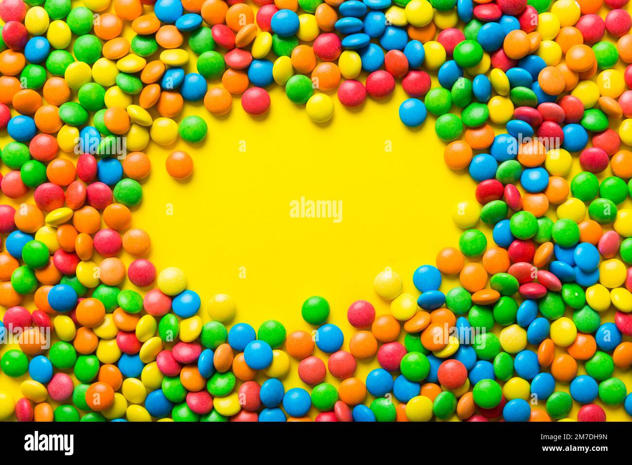 Mixed collection of colorful candy, on colored background. Flat lay ...