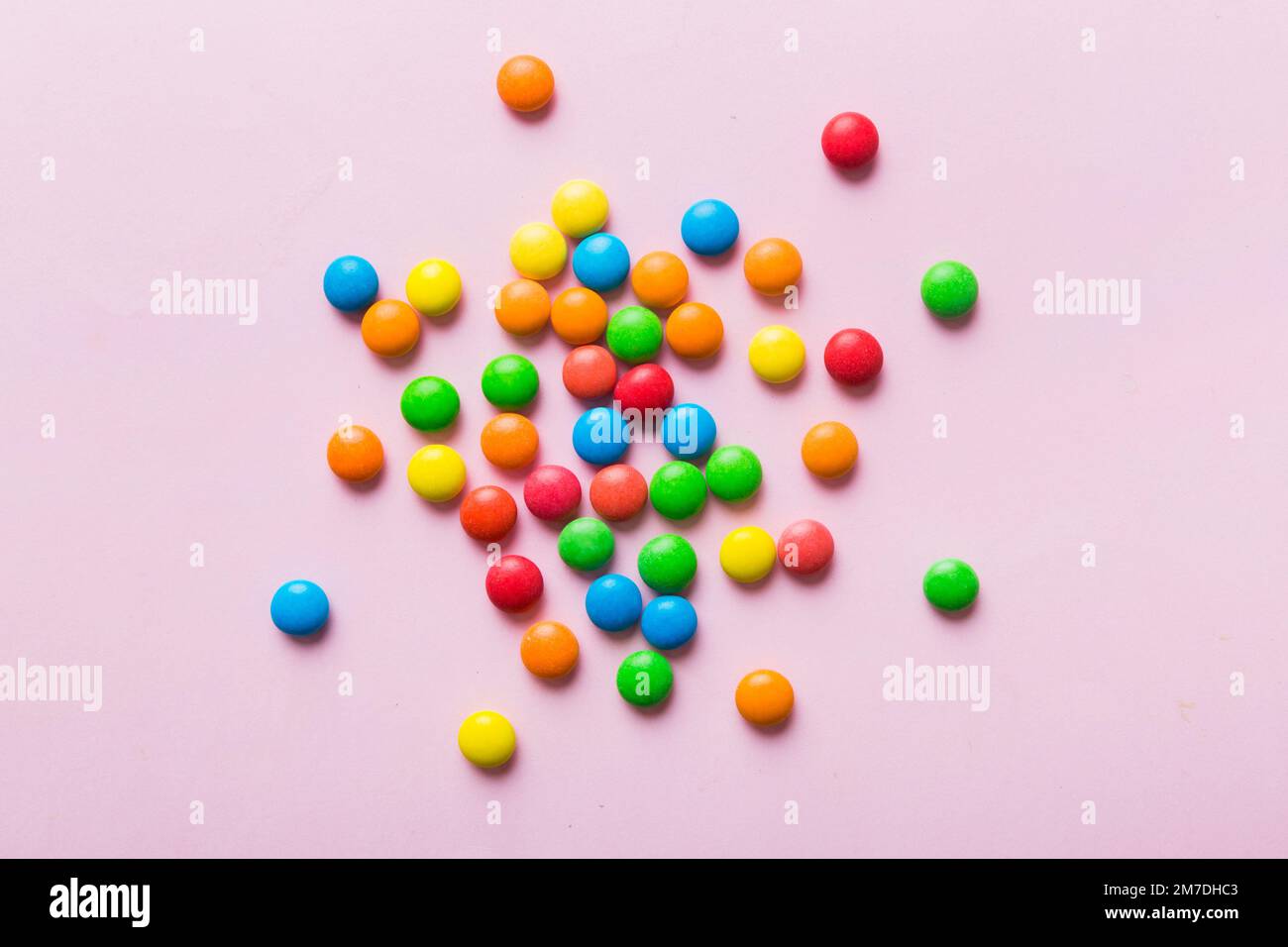 Mixed collection of colorful candy, on colored background. Flat lay ...