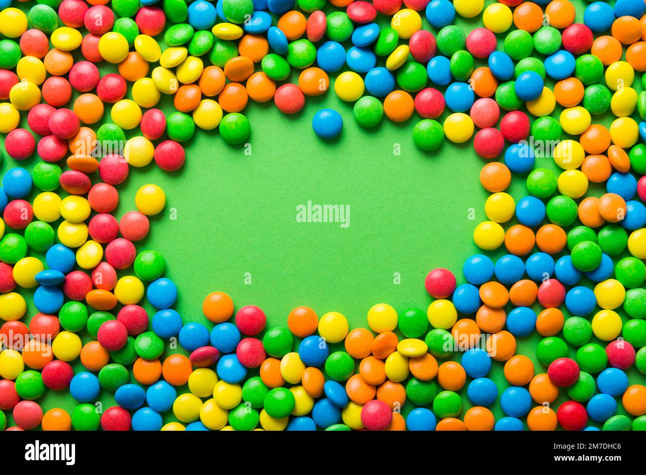 Mixed collection of colorful candy, on colored background. Flat lay ...