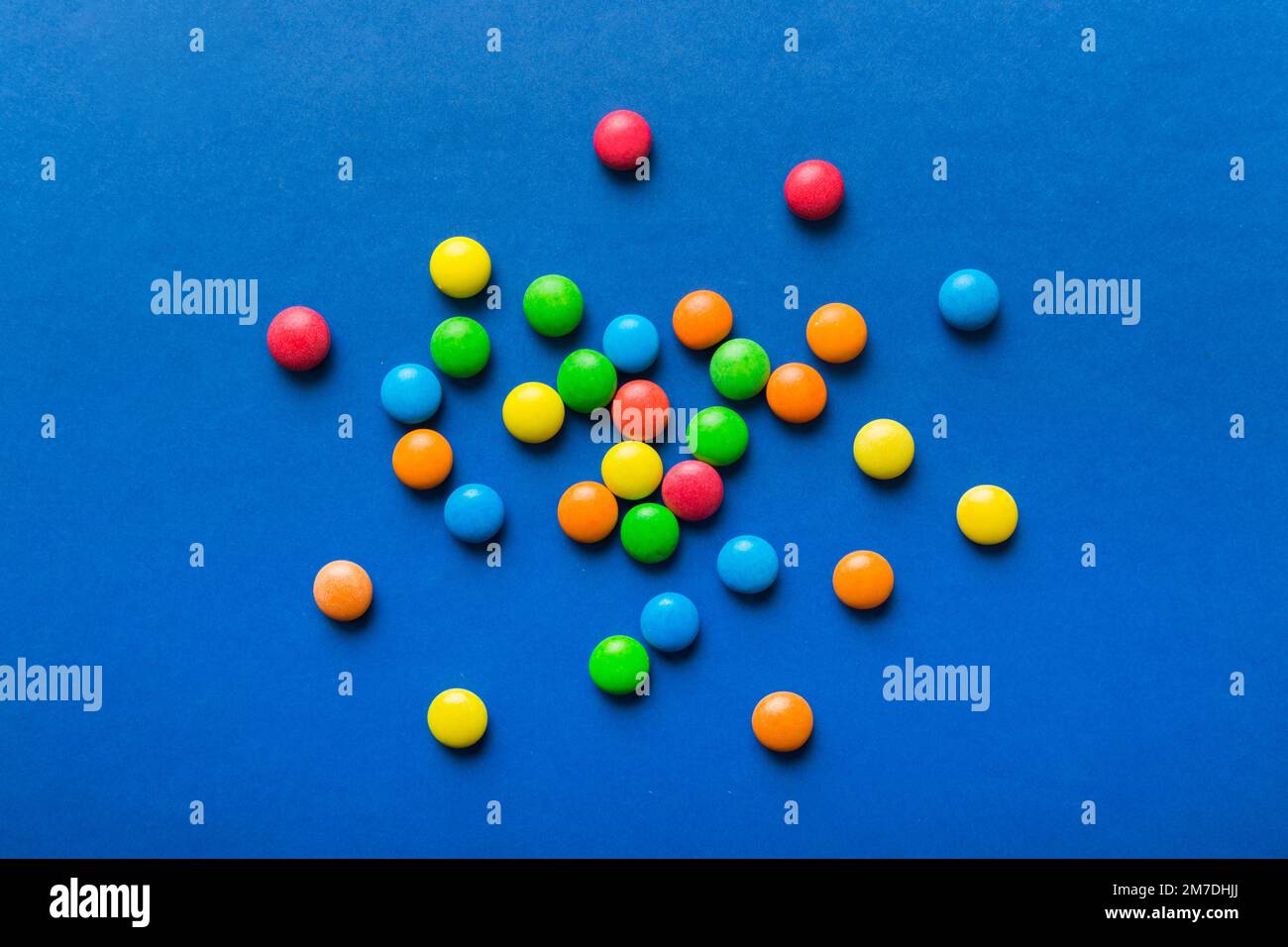 Mixed collection of colorful candy, on colored background. Flat lay ...