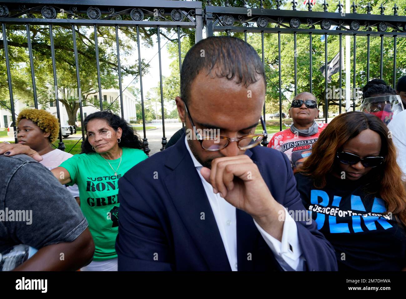 Mona Hardin, background left in green, mother of Ronald Greene, prays ...