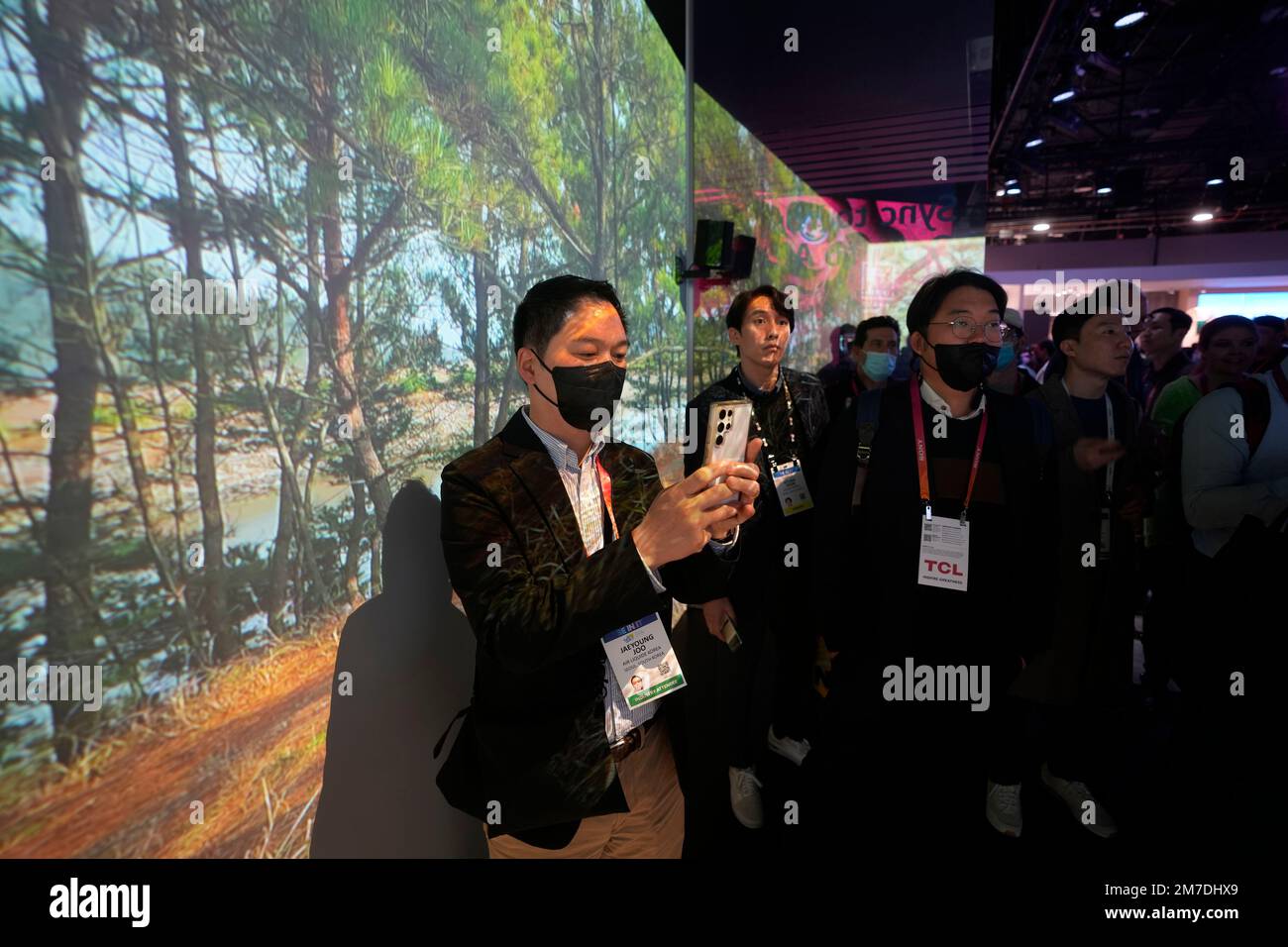 A CES attendees look on from the immersive room at the LG booth at the CES tech show, Thursday ...