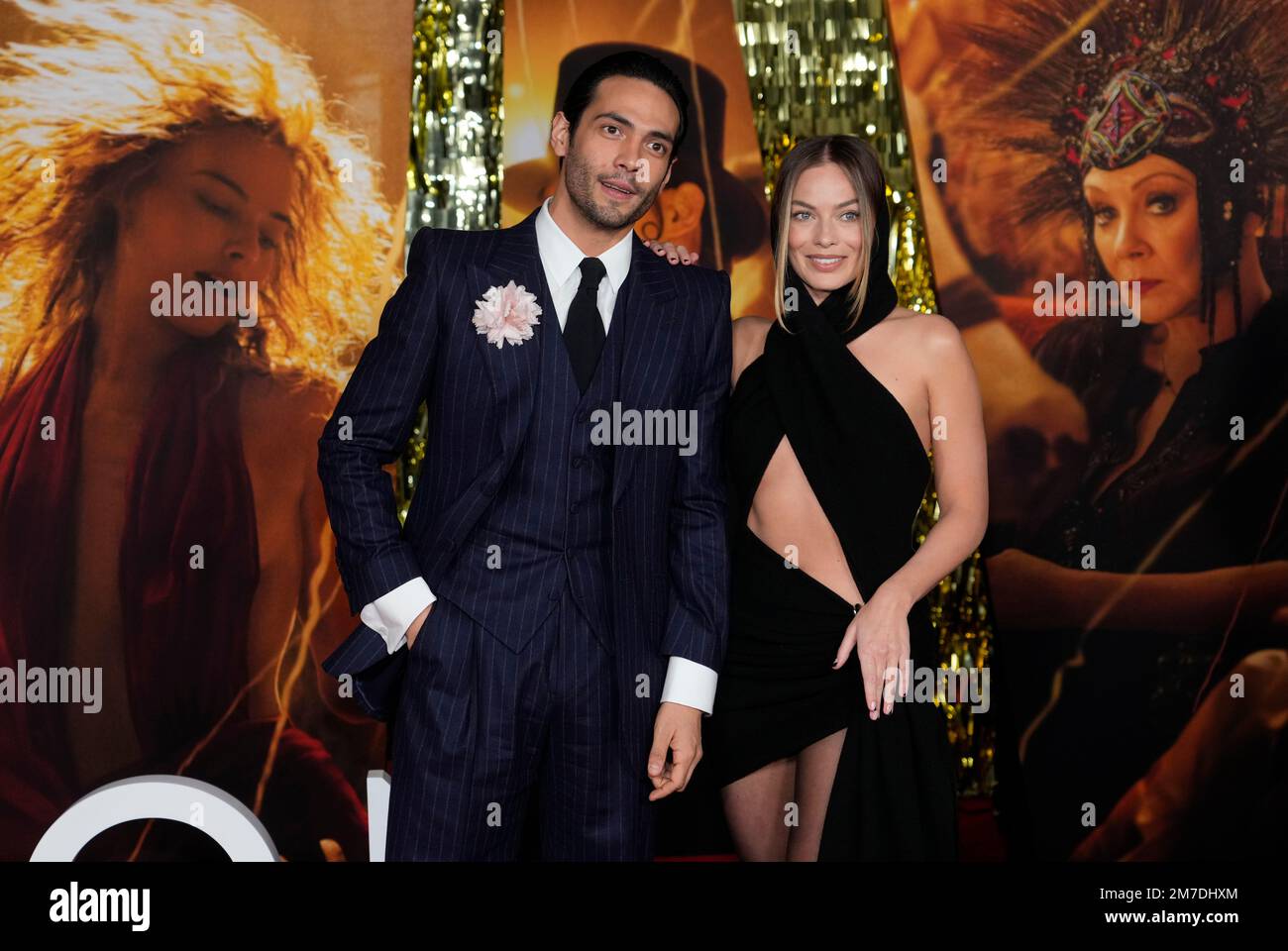 Diego Calva, left, and Margot Robbie, cast members in "Babylon," pose ...