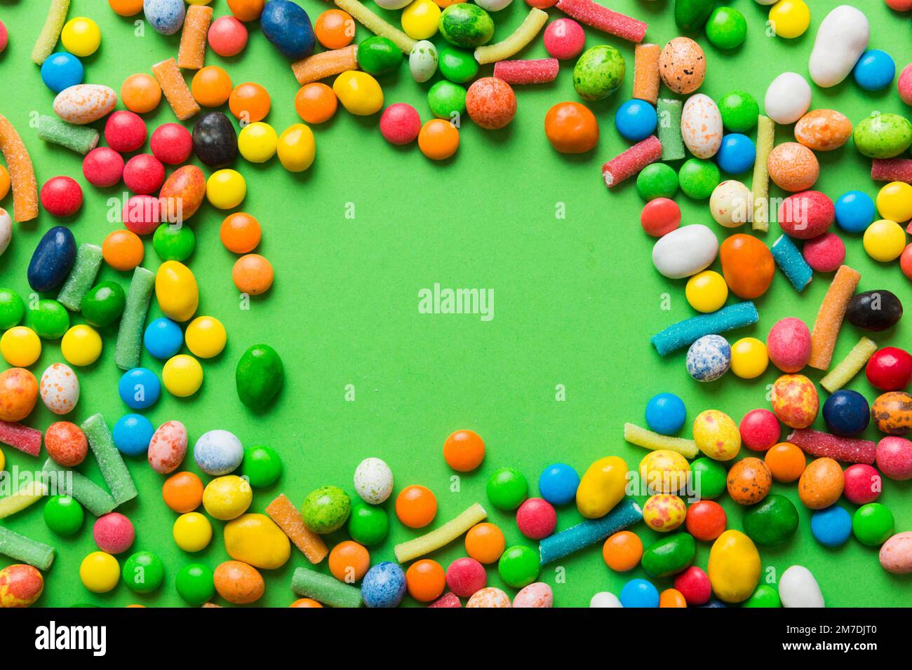 Mixed collection of colorful candy, on colored background. Flat lay ...