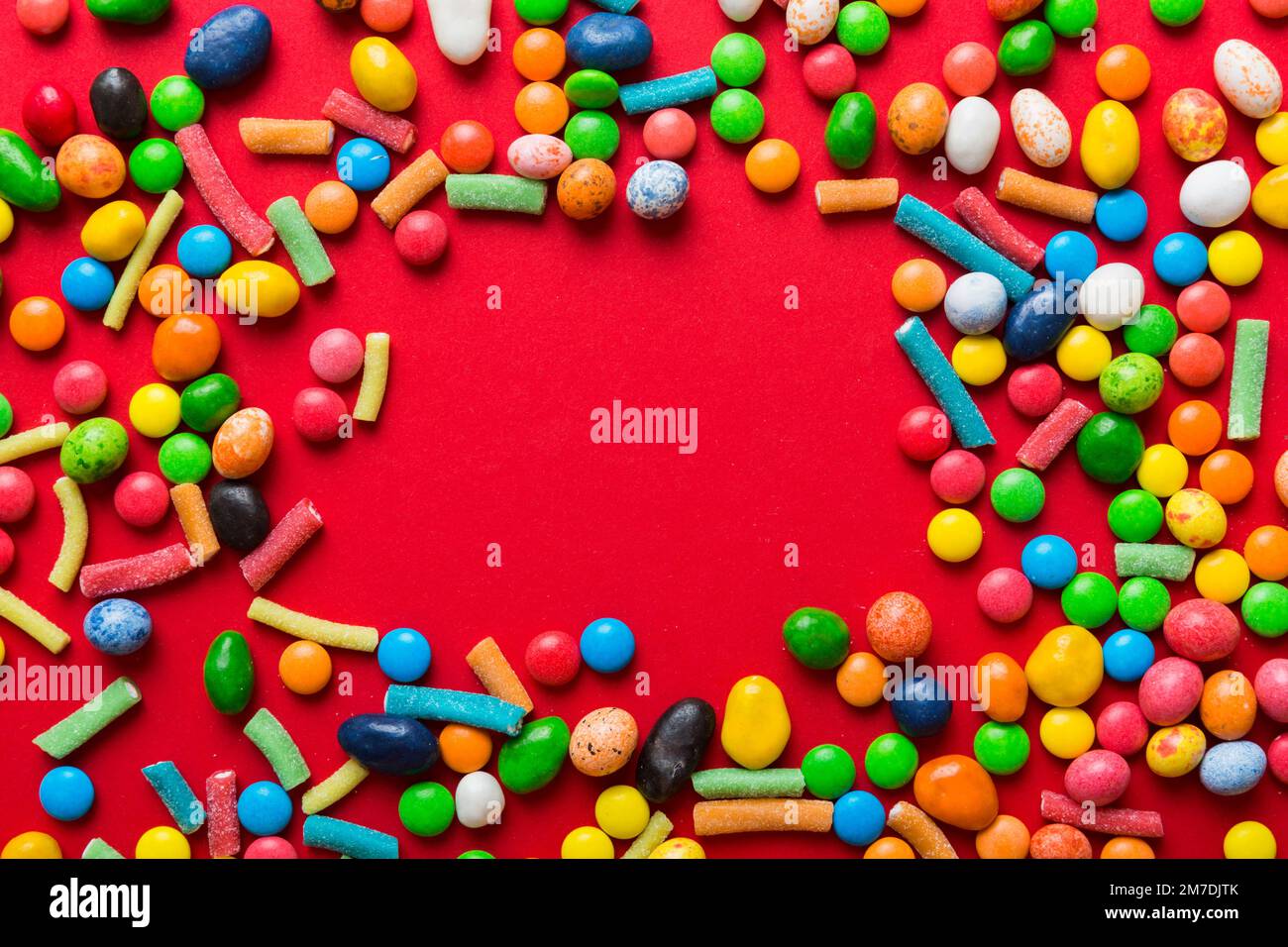 Mixed collection of colorful candy, on colored background. Flat lay ...