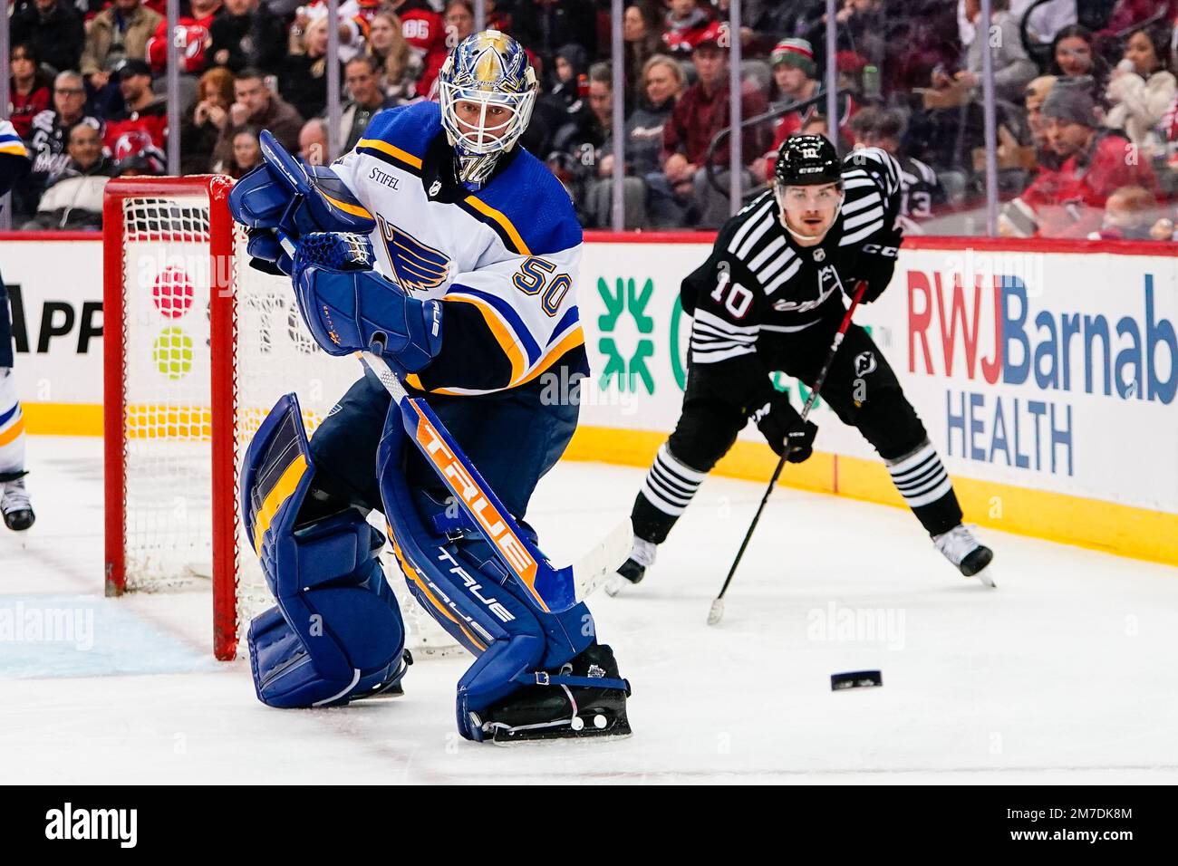 St. Louis Blues goaltender Jordan Binnington (50) passes the puck away ...