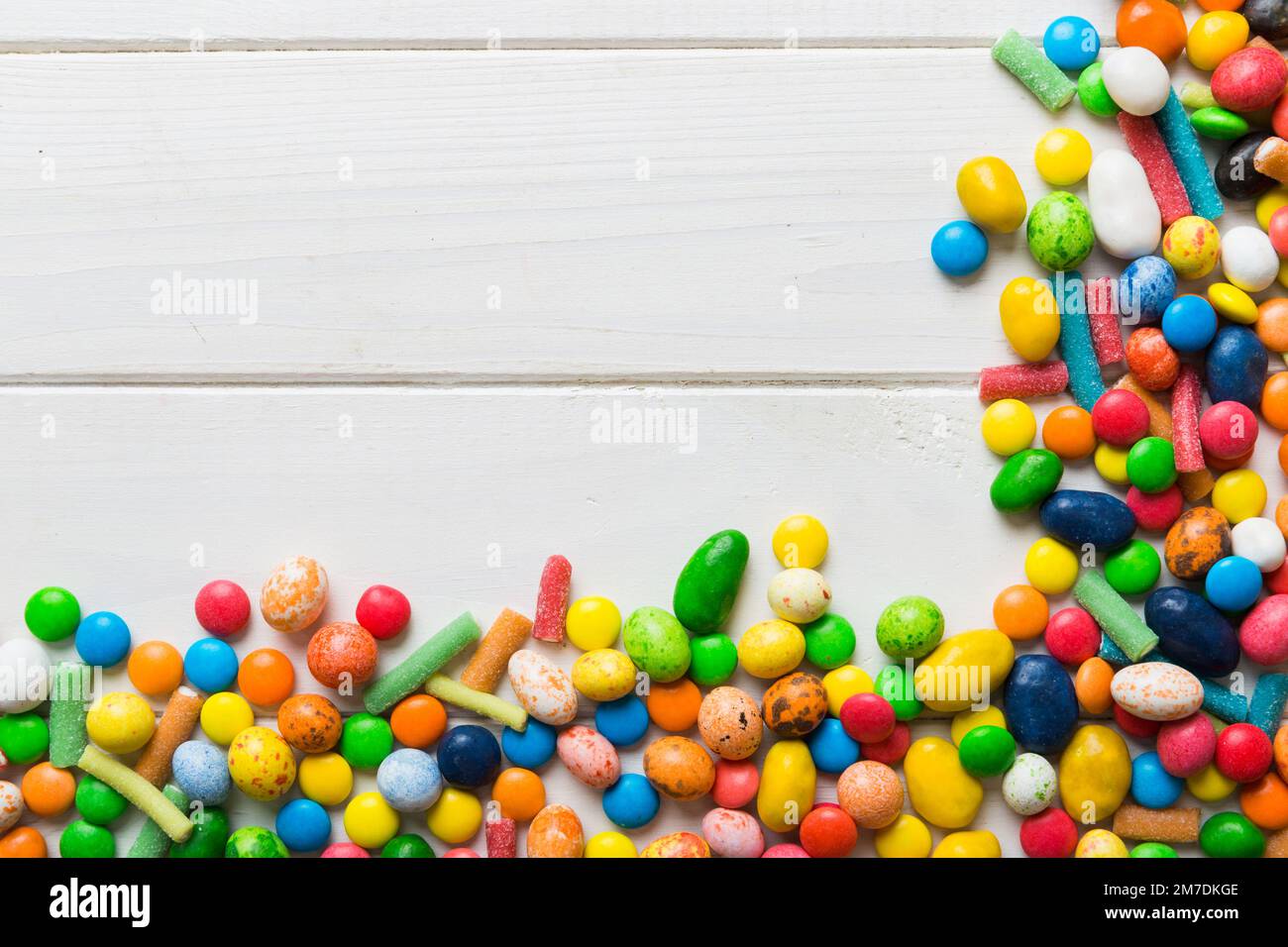 Mixed collection of colorful candy, on colored background. Flat lay ...