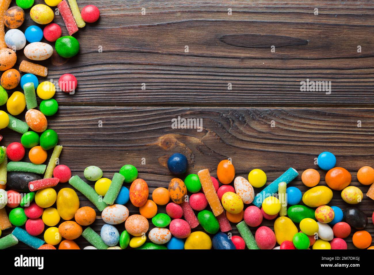 Mixed collection of colorful candy, on colored background. Flat lay ...
