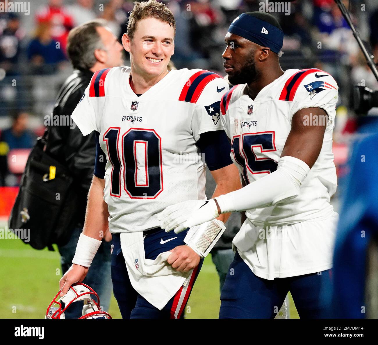 New England Patriots' Mac Jones (10) and Nelson Agholor (15) walk to ...
