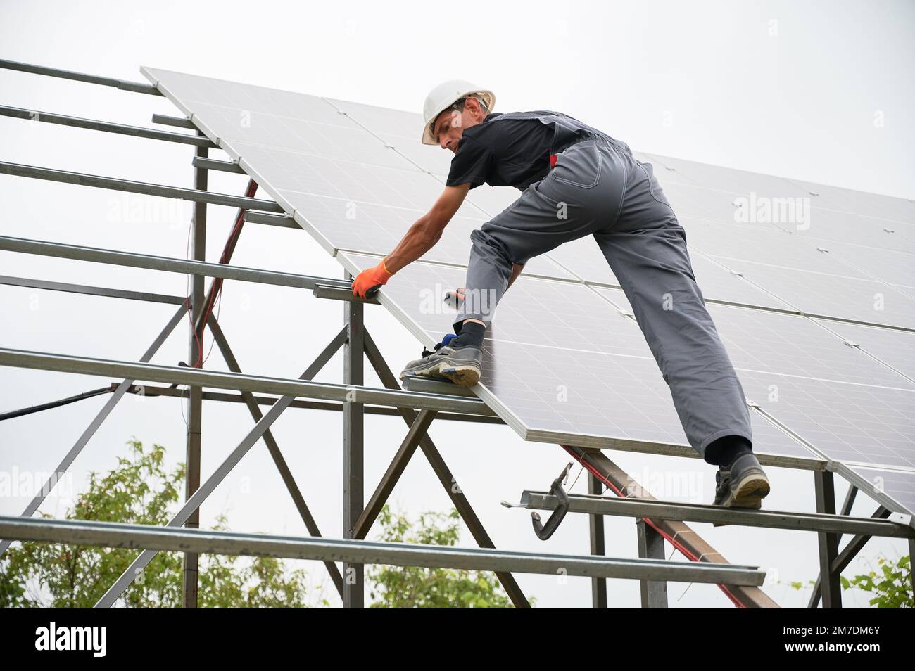 Man technician installing photovoltaic solar panels. Male worker in ...