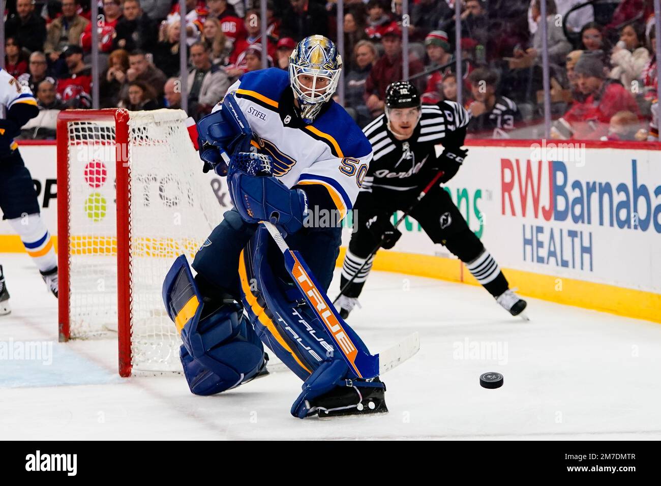 St. Louis Blues goaltender Jordan Binnington (50) passes the puck away ...