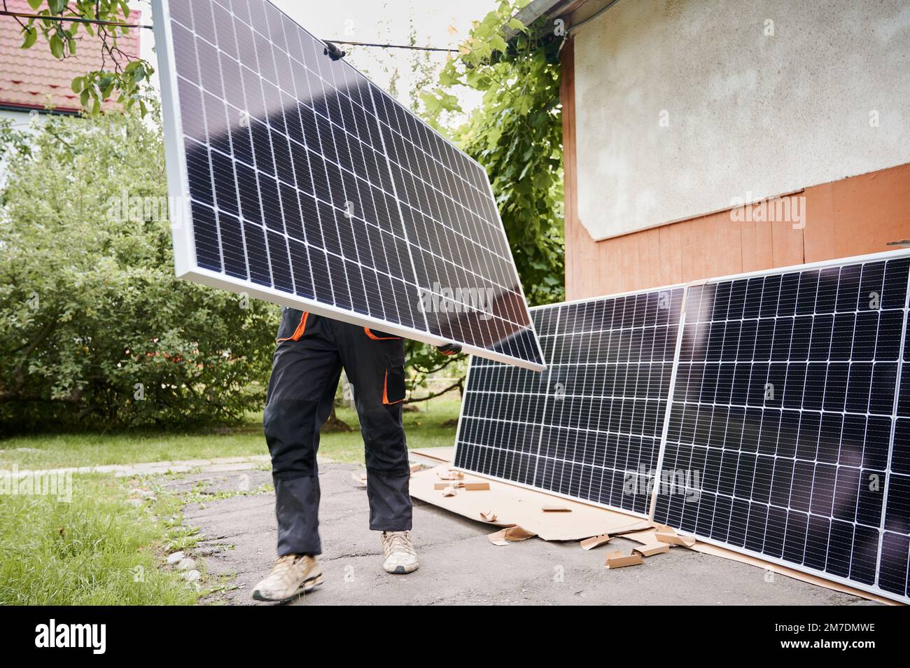 Worker holding and carrying solar panel for installing. Motion blur ...