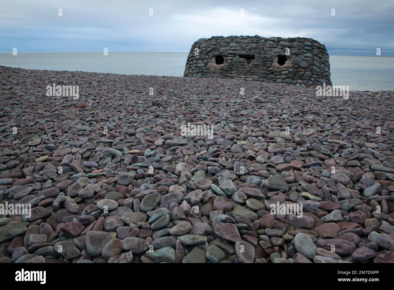 The beach at Porlock Weir in somerset UK with an old gun emplacement ...