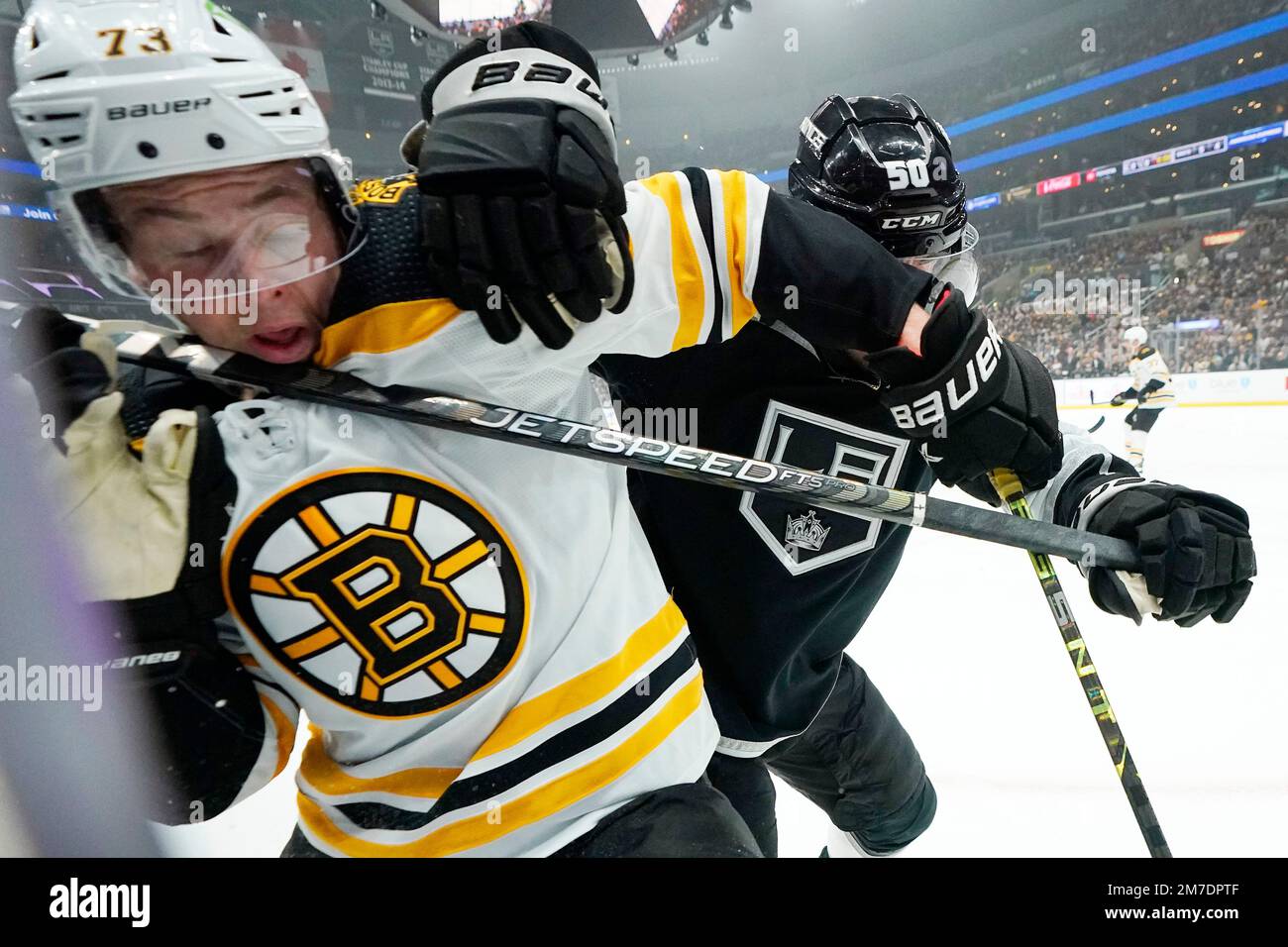 Boston Bruins defenseman Charlie McAvoy, left, takes a stick to the ...