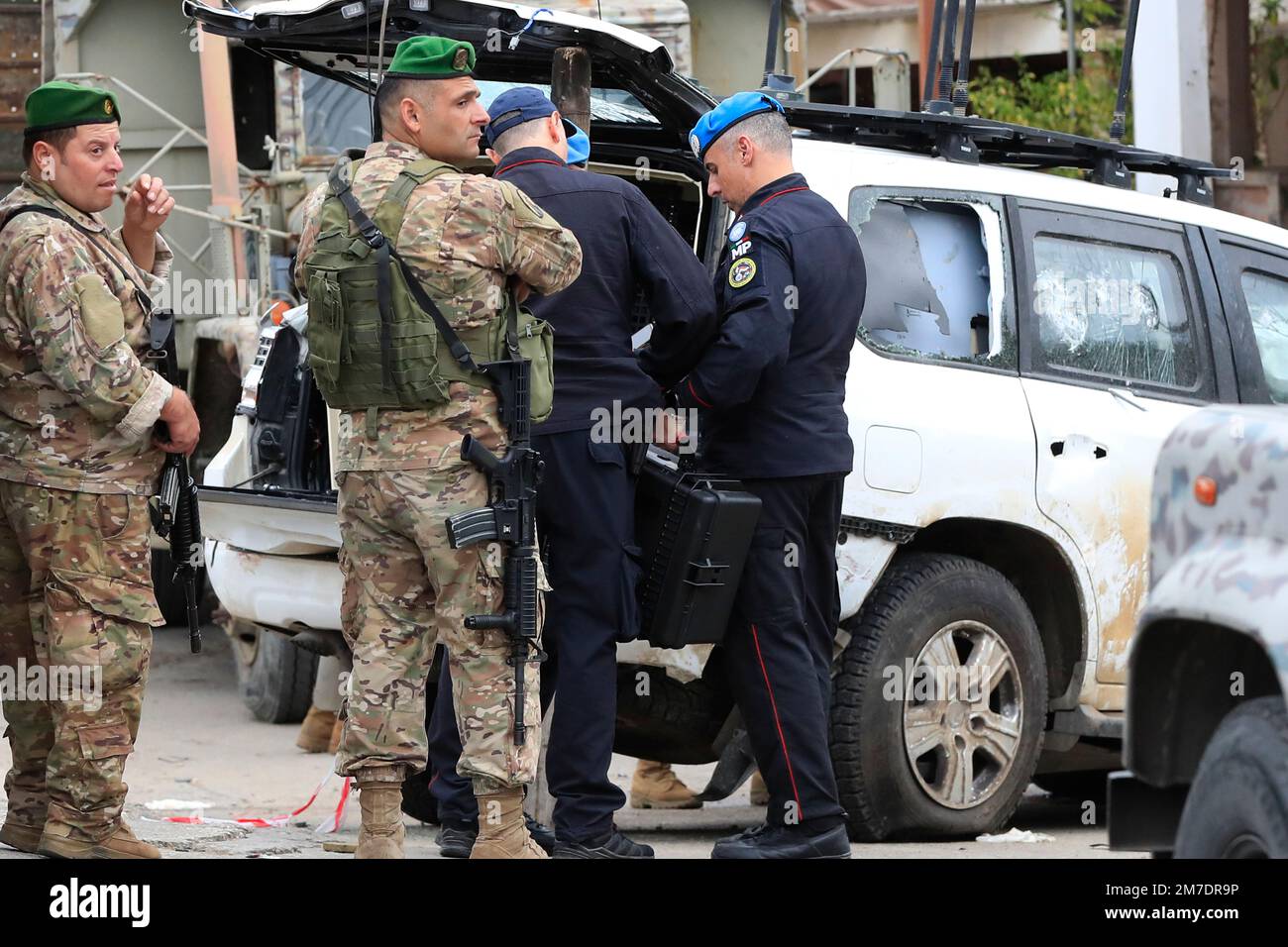 UN peacekeepers military police, right, investigate a damaged UN ...