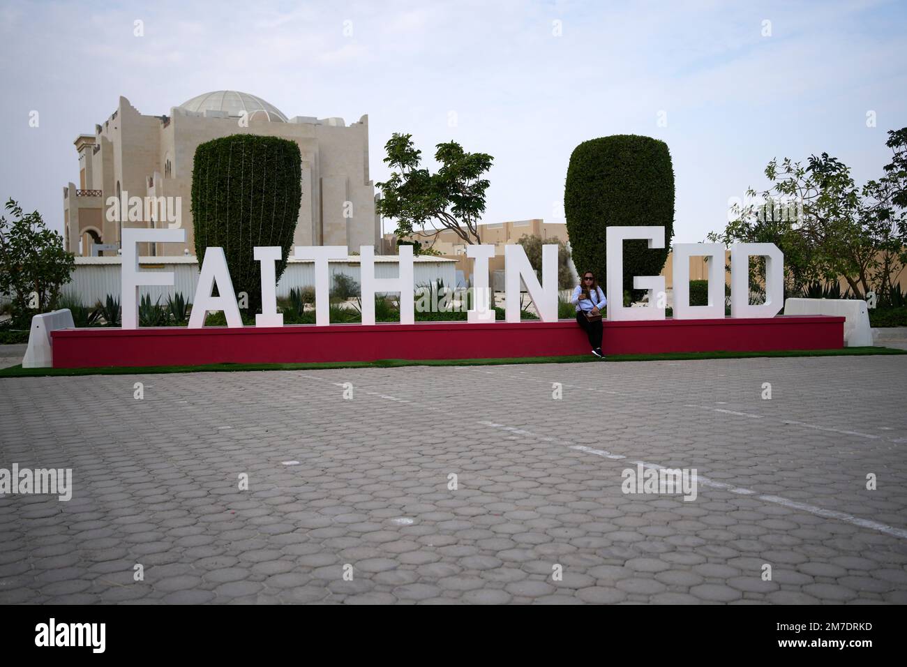People sit outside the Catholic Church, Our Lady of the Rosary, at the ...