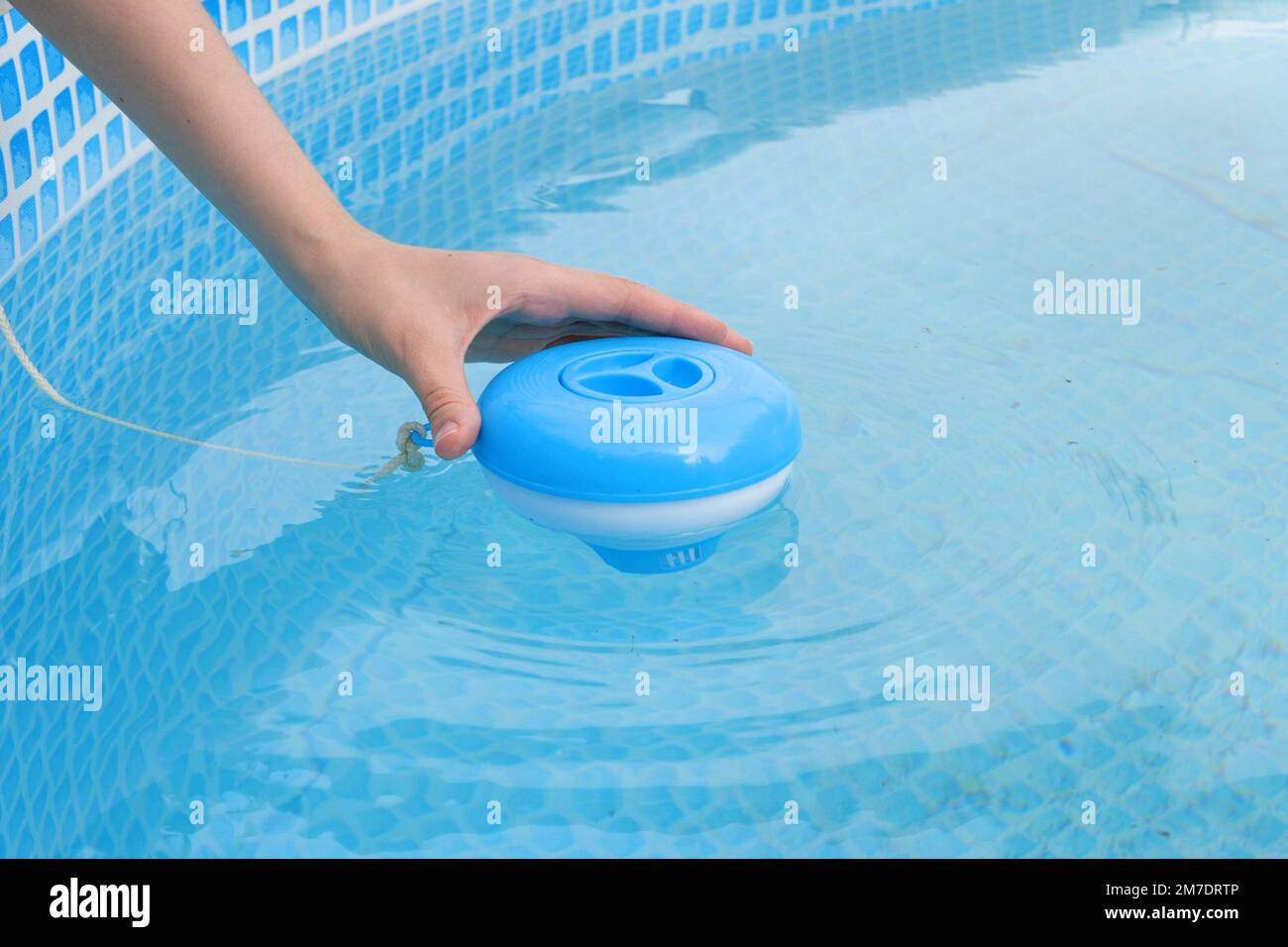 Worker hands isinfection and chlorination of water in the pool ...
