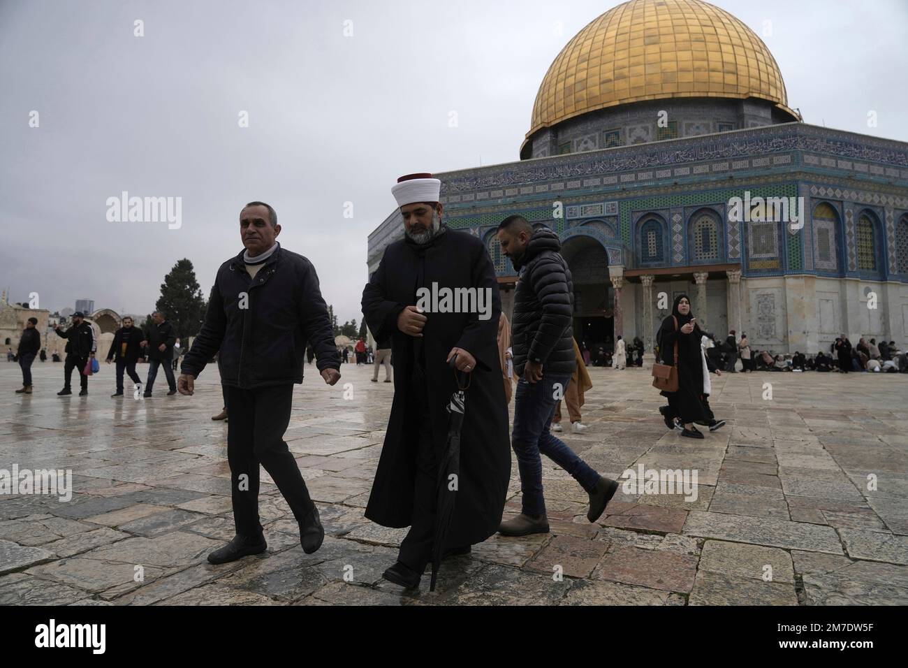 A Muslim holy man walks from the Dome of the Rock Mosque as worshippers ...