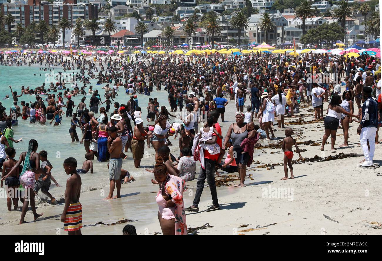 People enjoy New Year's day at Camps Bay beach in Cape Town, South ...