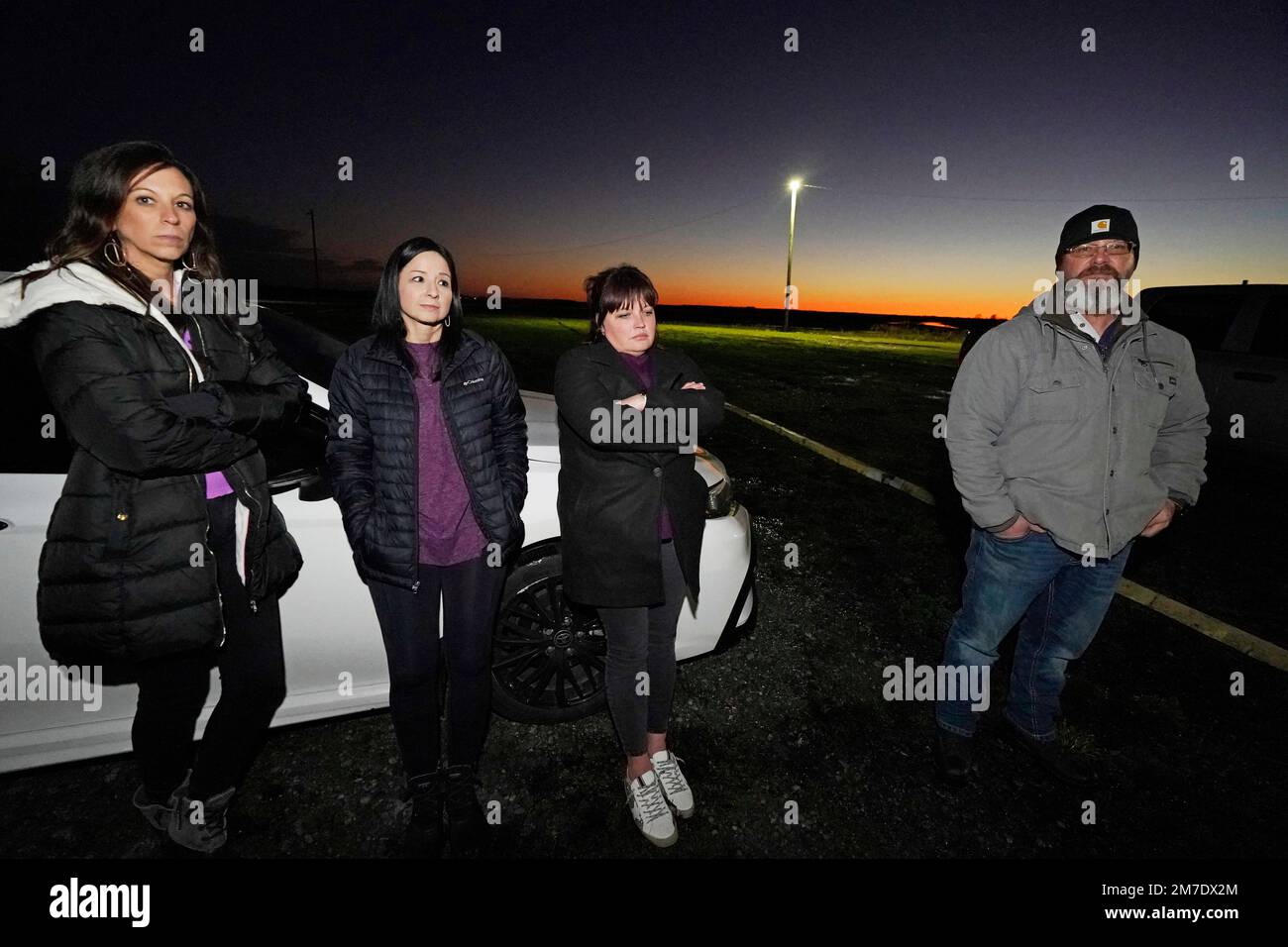 A small group of people gather in support of the mother and family of ...