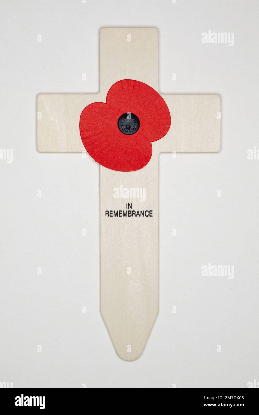 A simple wooden cross with a red poppy used in remembrance of those who ...