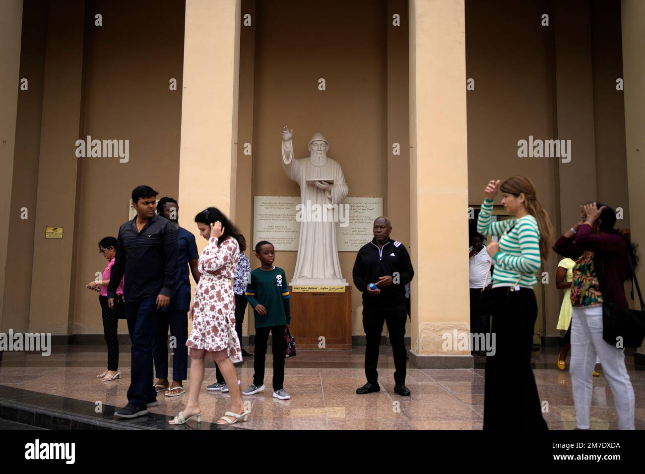 People stand outside the Catholic Church, Our Lady of the Rosary, at ...