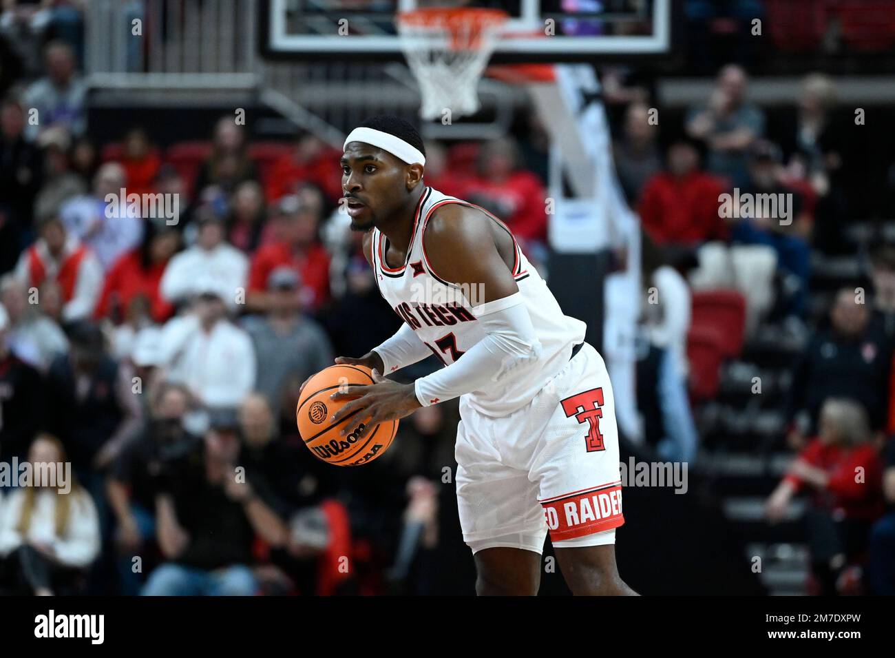 Texas Tech guard De'Vion Harmon controls the ball against Kansas during ...