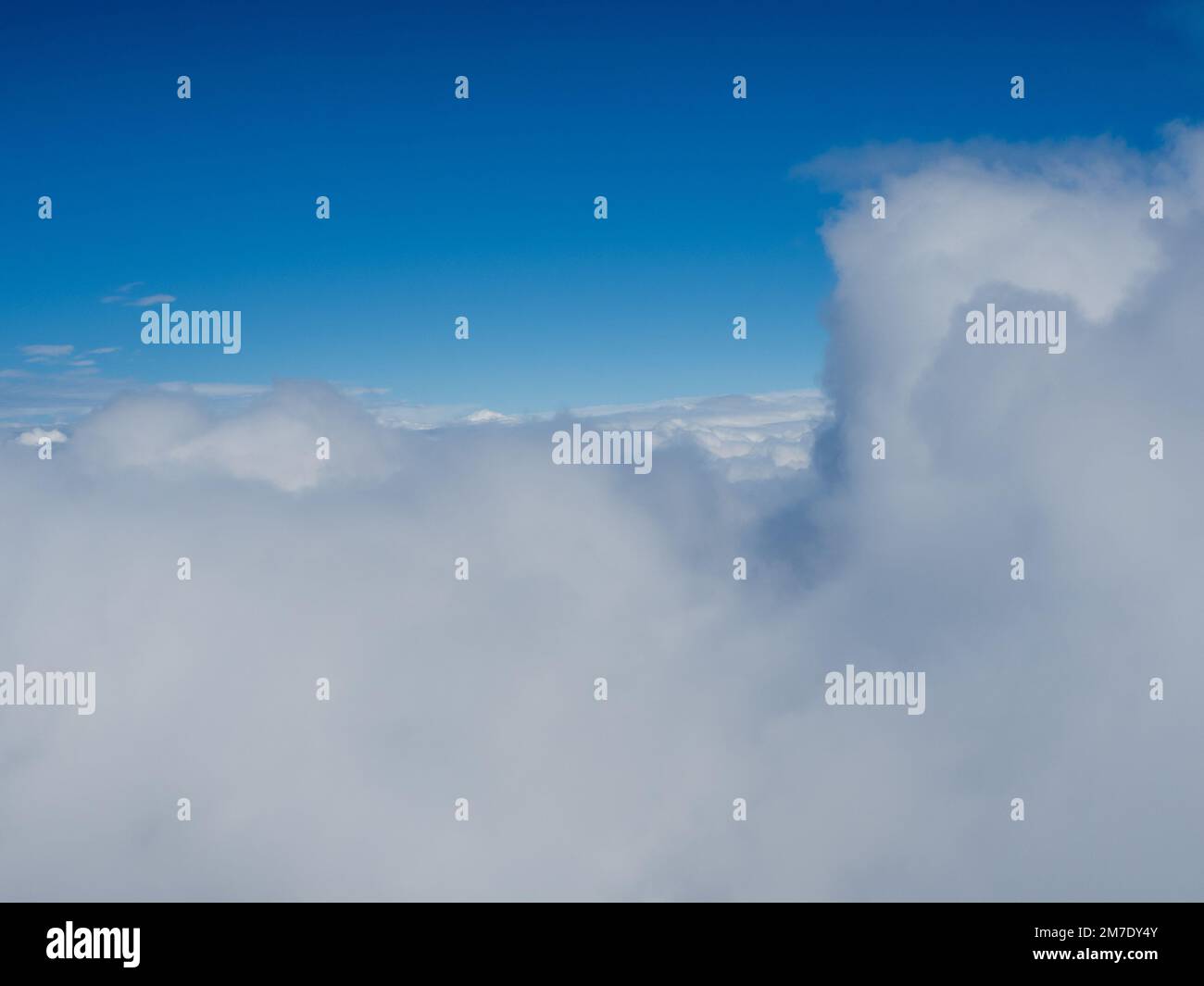 High white clouds with very blue sky, fluffy texture seen from the ...