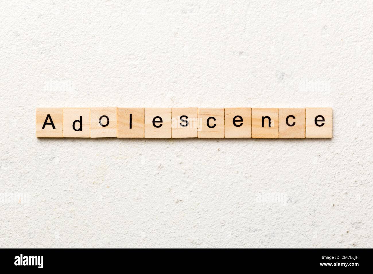 adolescence word written on wood block. adolescence text on table ...